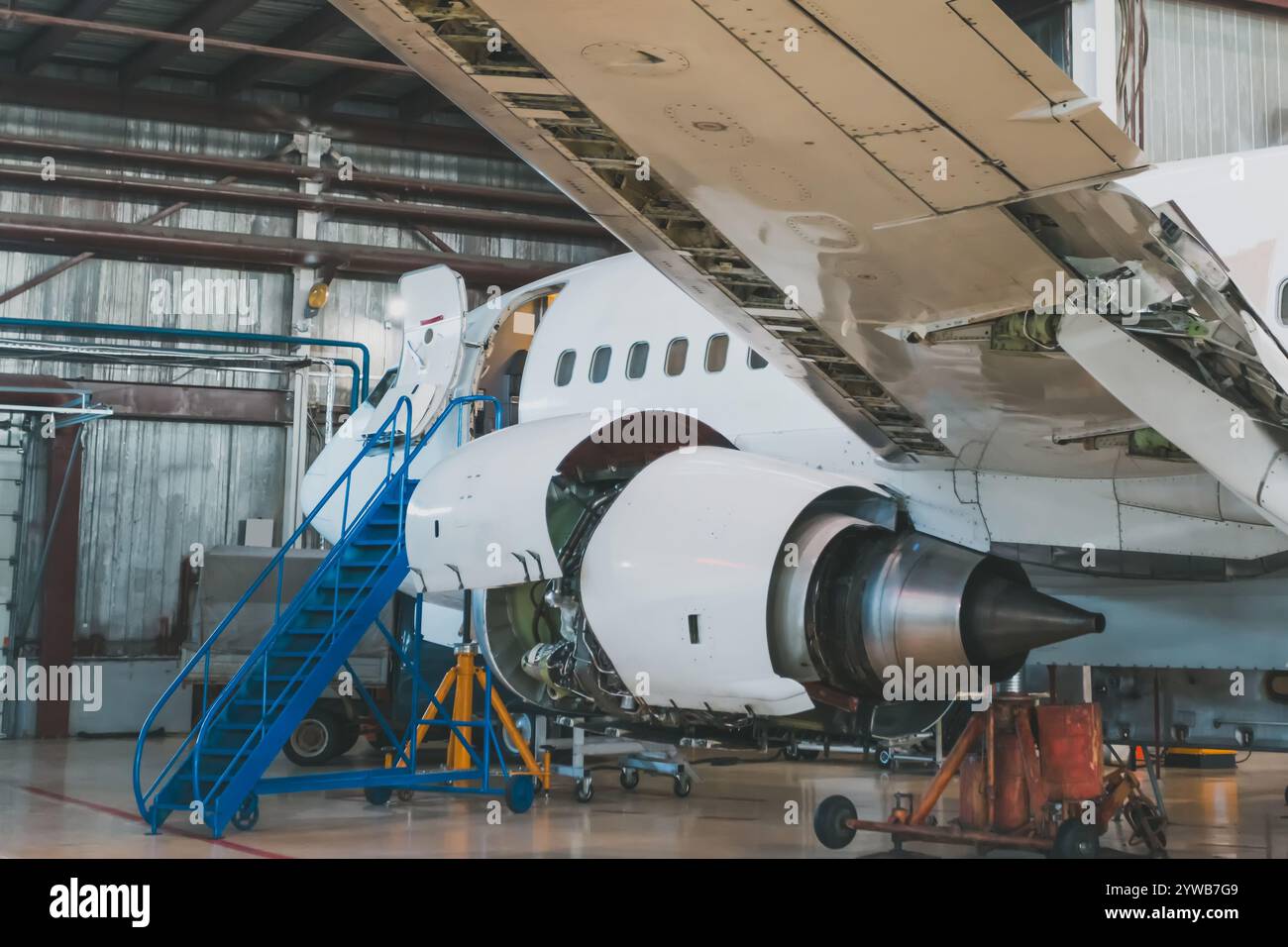 Close-up of a white passenger jetliner with engine open in the airplane ...