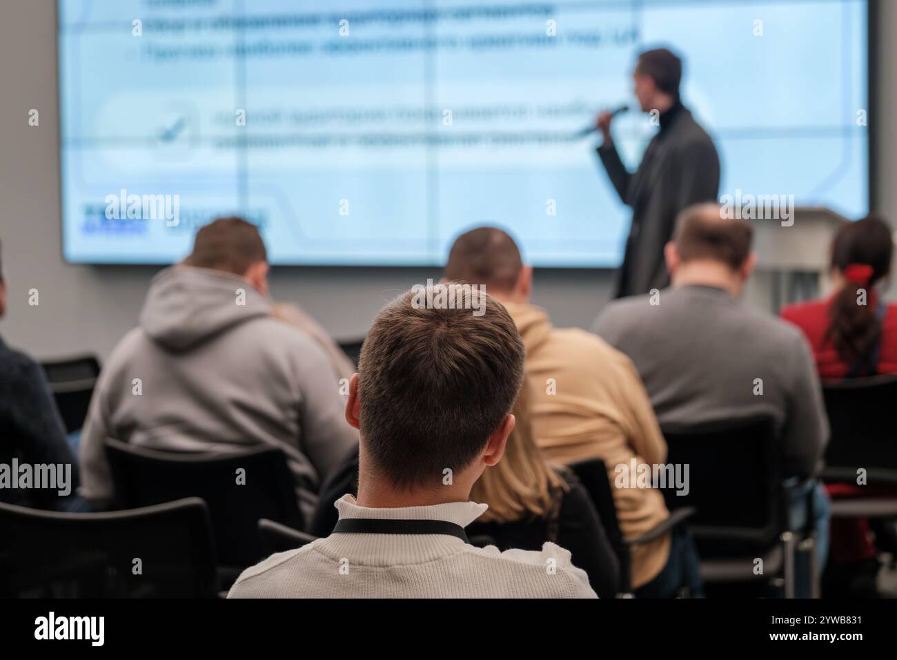 Audience attending a business presentation with speaker using ...