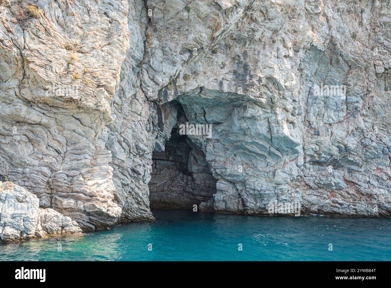 Phosphorous cave in the cliffs of southwestern coast of Cennet Island ...