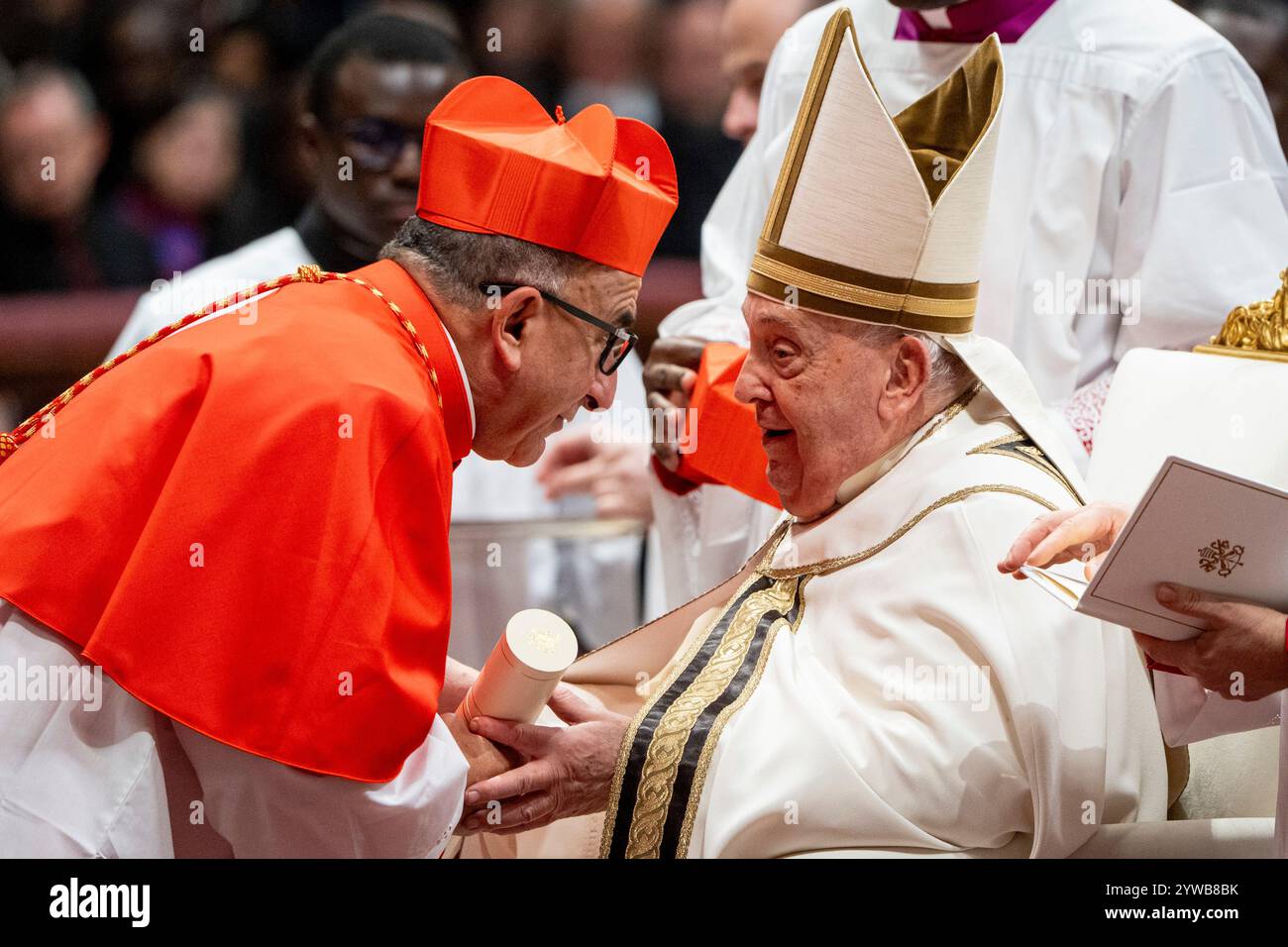 Pope Francis places the Cardinal's hat on the head of the new Cardinal ...