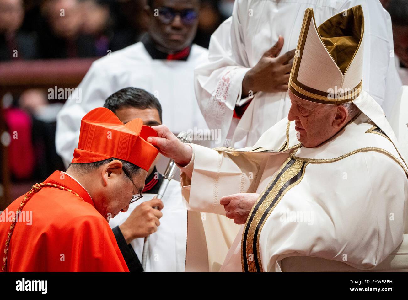 Pope Francis places the Cardinal's hat on the head of the new Cardinal ...