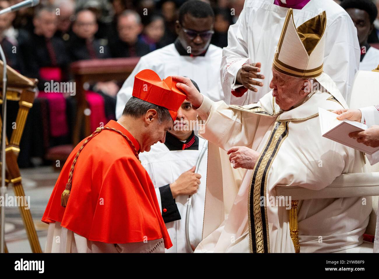 Pope Francis places the Cardinal's hat on the head of the new Cardinal ...