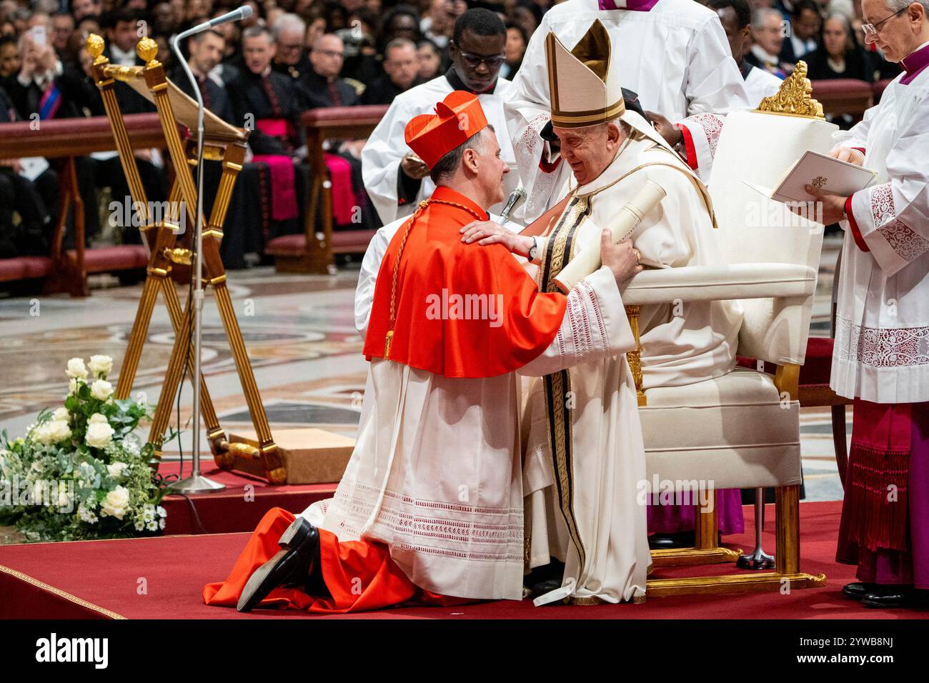 Pope Francis places the Cardinal's hat on the head of the new Cardinal ...