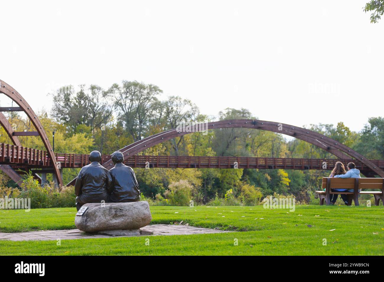 Old Lovers sitting on Rock and Young Lovers Sitting on Bench in Public ...