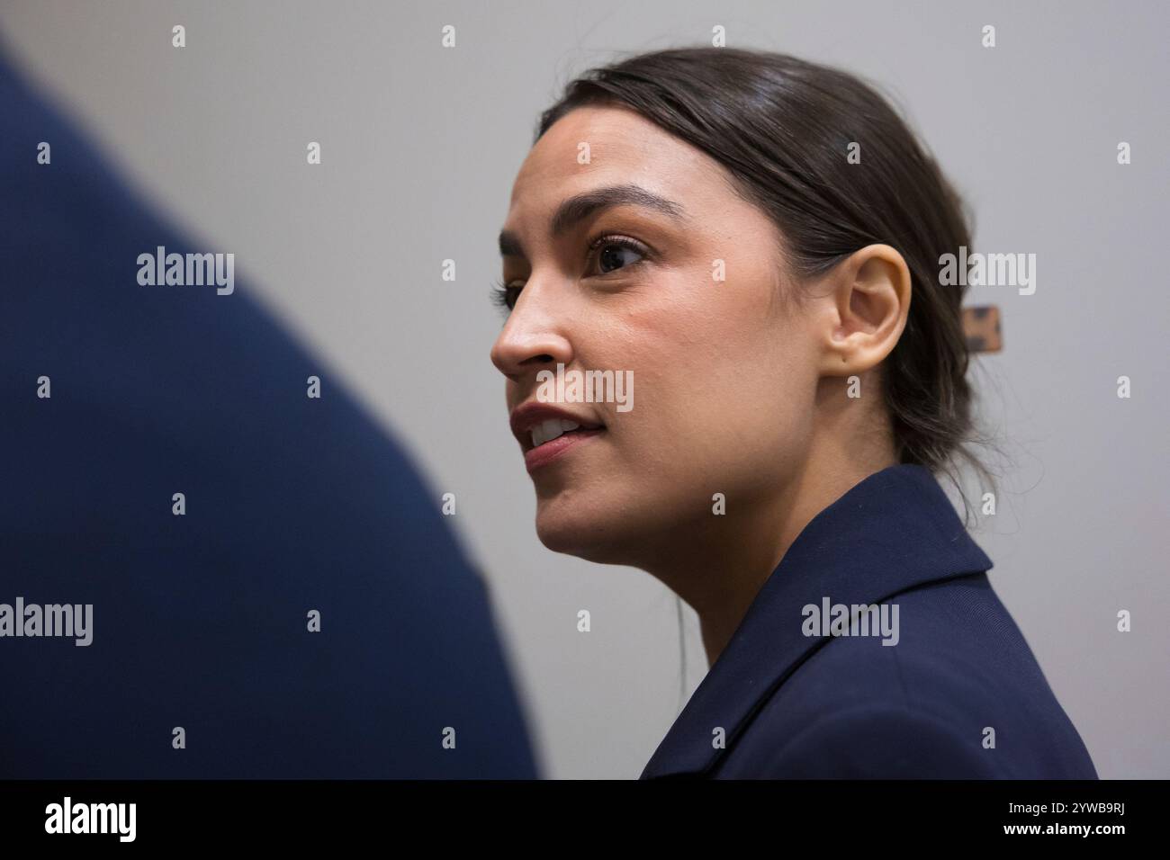 Rep. Alexandria Ocasio-Cortez (D-N.Y.) speaks with an aide as she ...