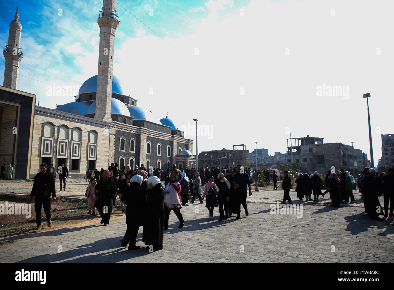 Homs, Syria. 08 December 2024. Bystanders outside the Khalid ibn al ...
