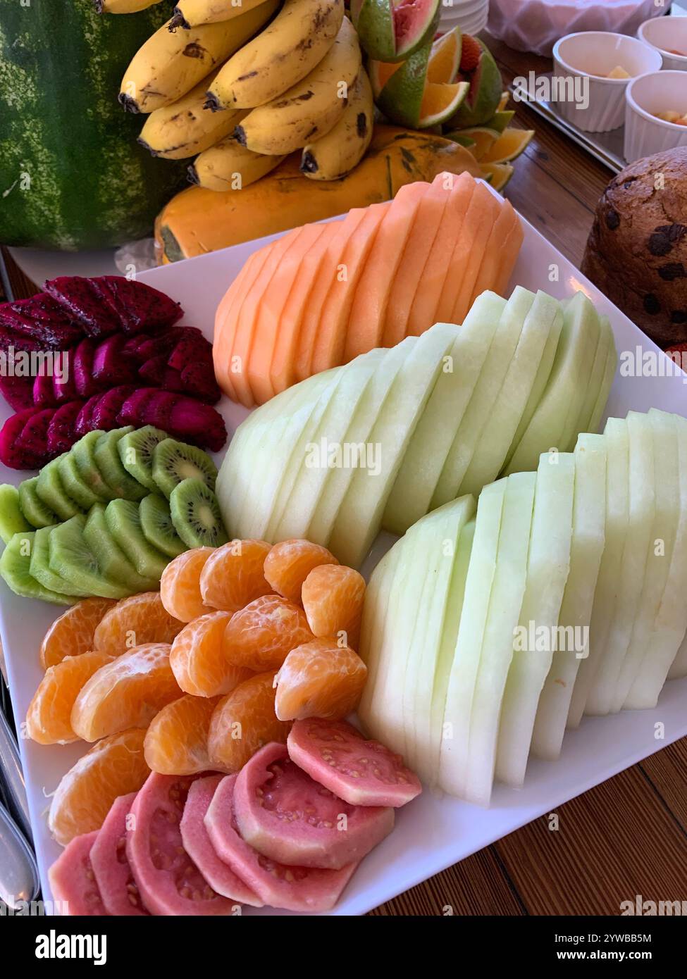 Fruit platter with slice fruit: melon, tangerine, guava, kiwi and ...