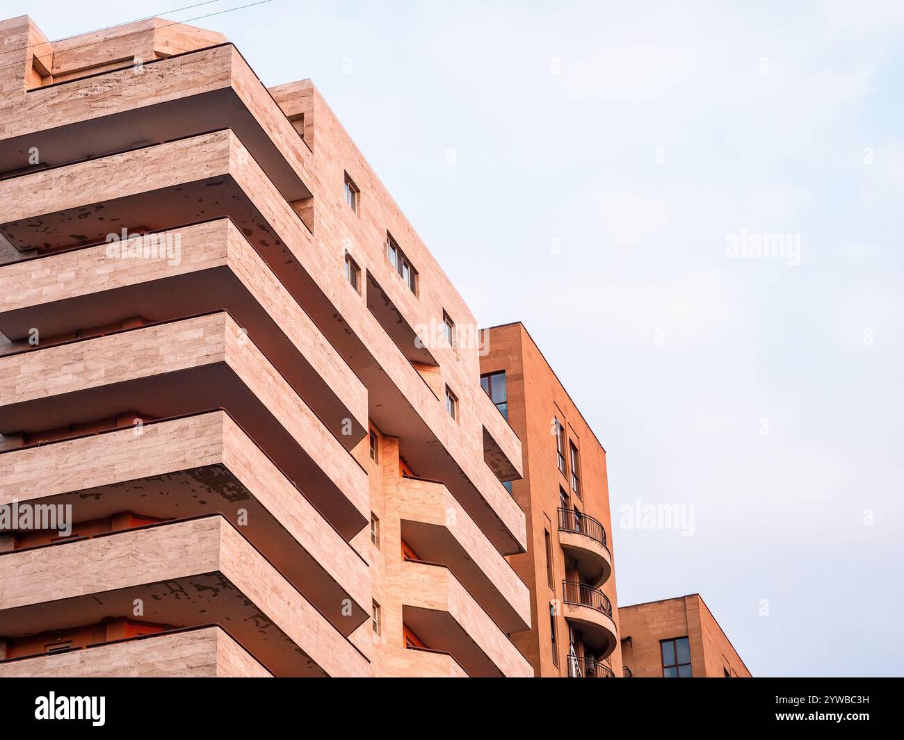 pink high-rise apartment building in Yerevan city in winter evening ...