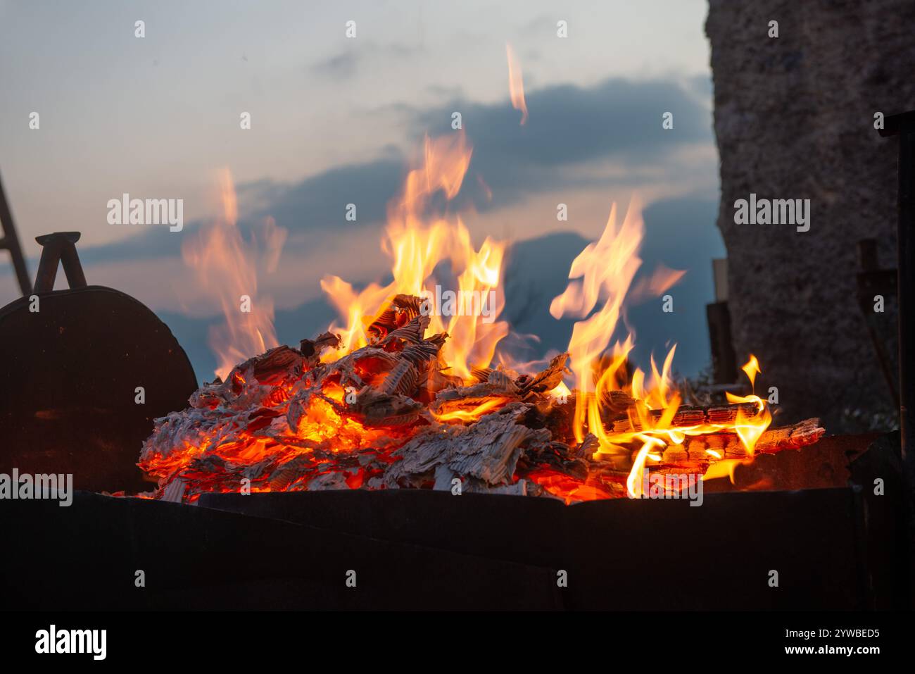 Brazier lit with flame and very lively embers Stock Photo - Alamy