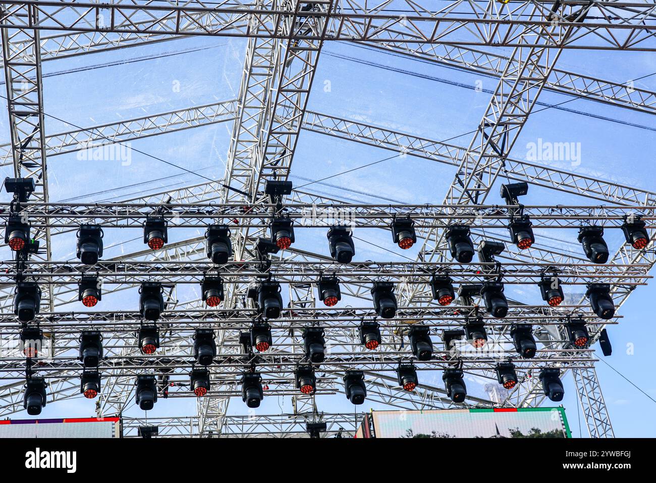Fragment of metal trusses and lighting elements of a large outdoor stage, aluminum concert stage ...
