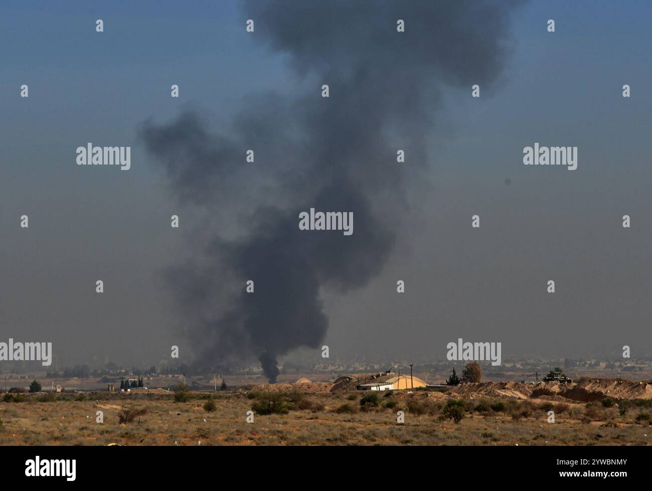 Damascus, Syria. 9th Dec, 2024. Smoke rises following an Israeli ...