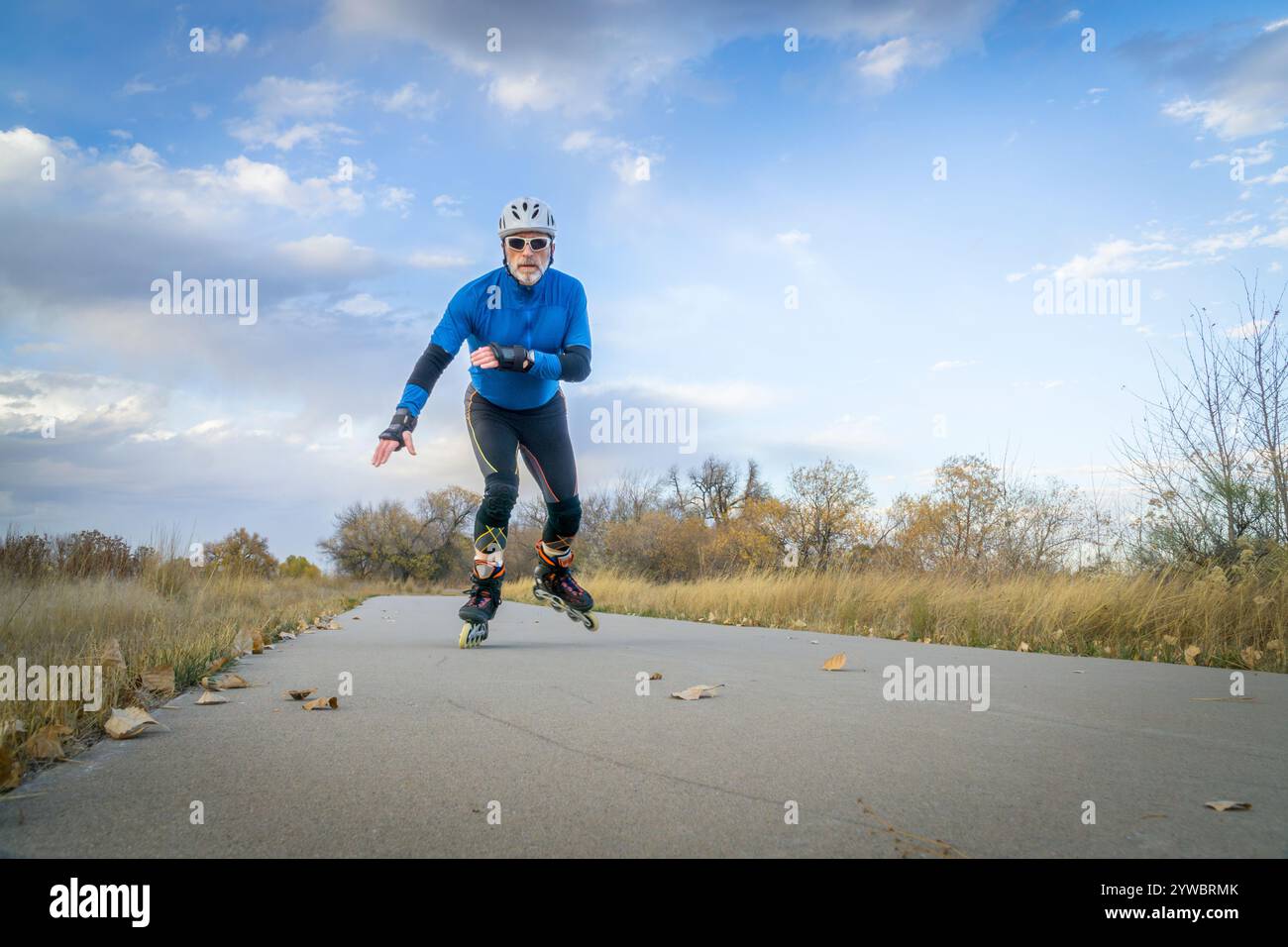 Senior athletic male inline skating on the Poudre RIver Trail in ...