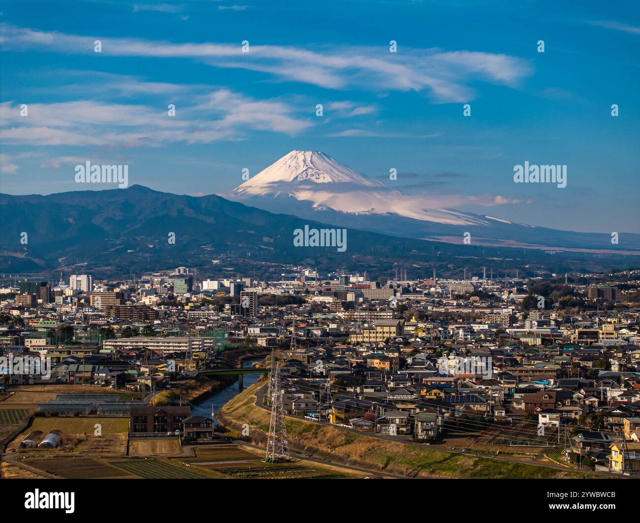 Majestic Mount Fuji overlooks a vibrant Japanese city, showcasing the ...