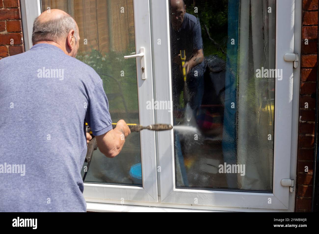 Caucasian men using pressure washer hi-res stock photography and images ...