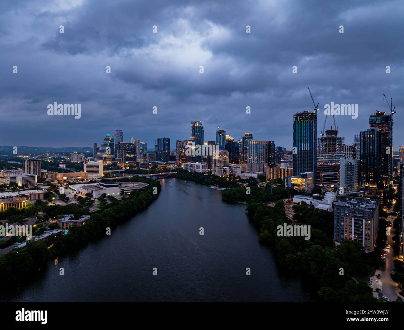 Austin, Texas skyline shining on the waters of Colorado River, creating ...