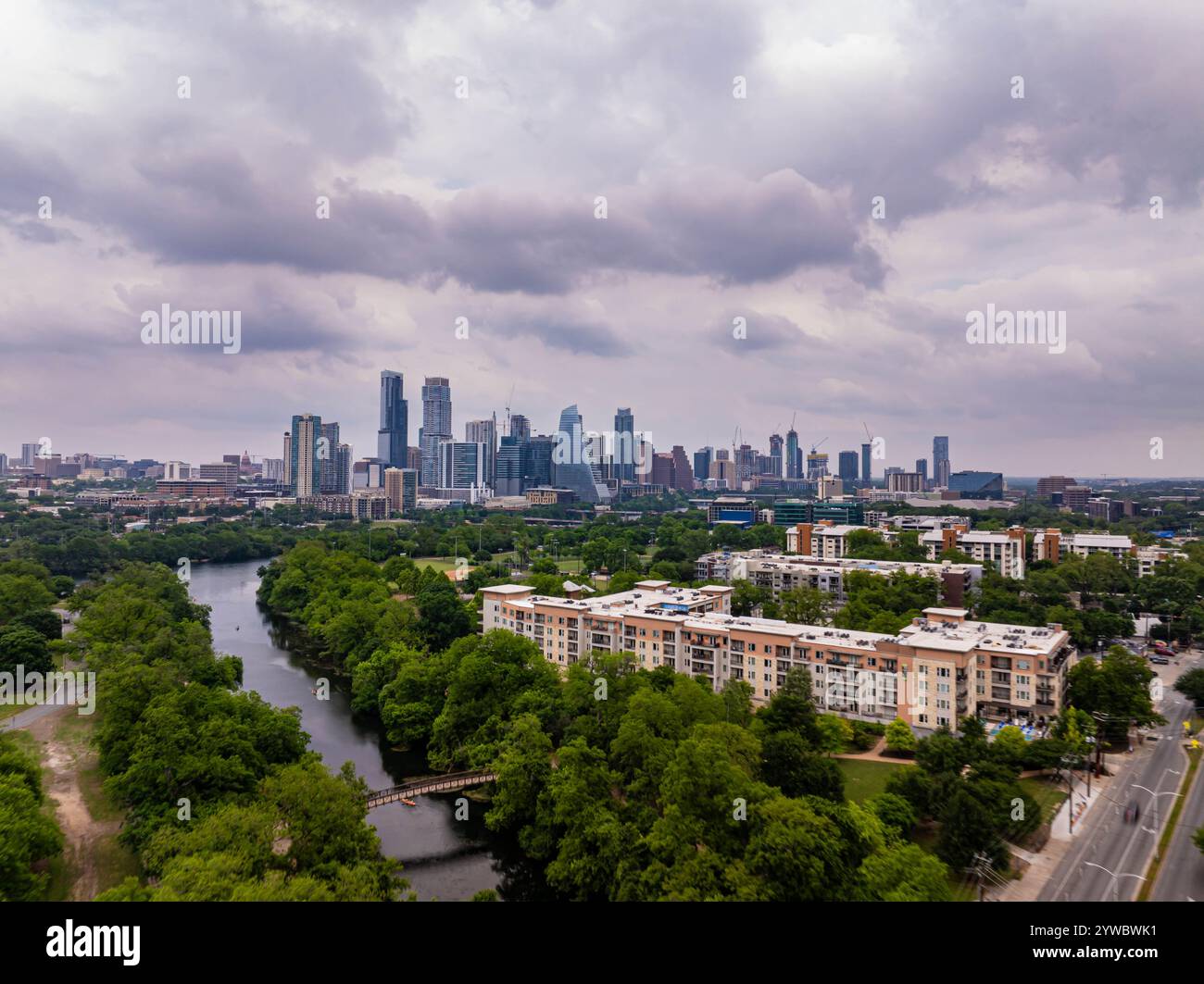 Austin, Texas skyline peeking through lush greenery and river ...