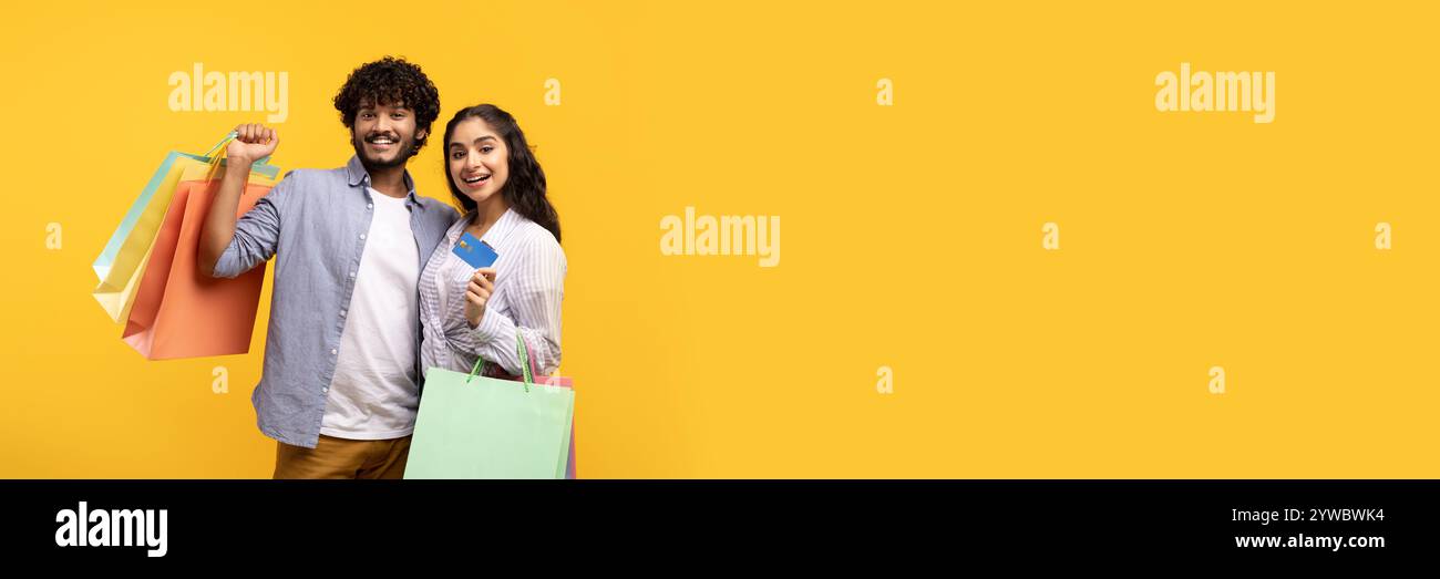 Easy payment. Portrait of indian couple showing debit credit card ...