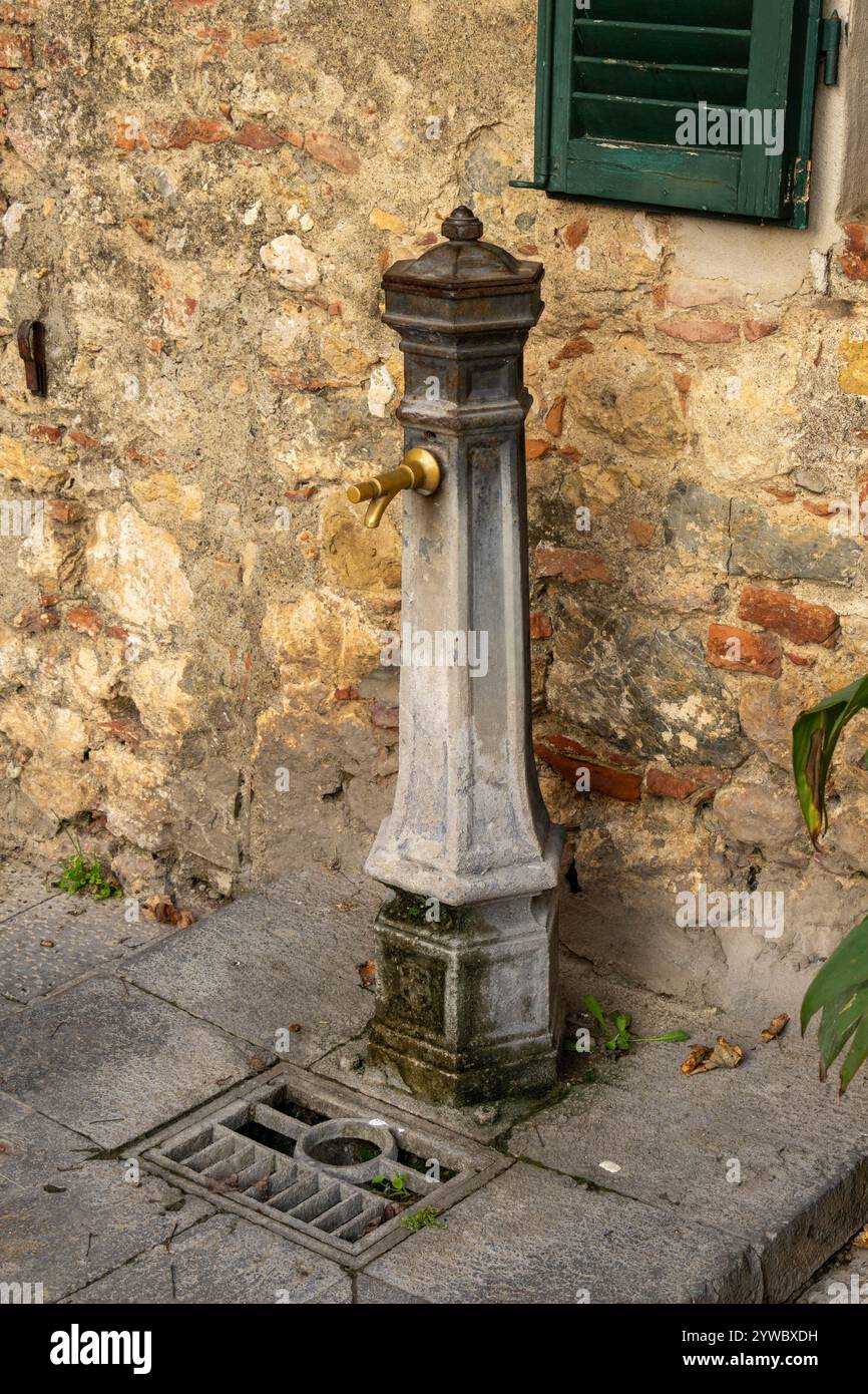 A water fountain in the medieval walled town of Monteriggioni, Sienna ...