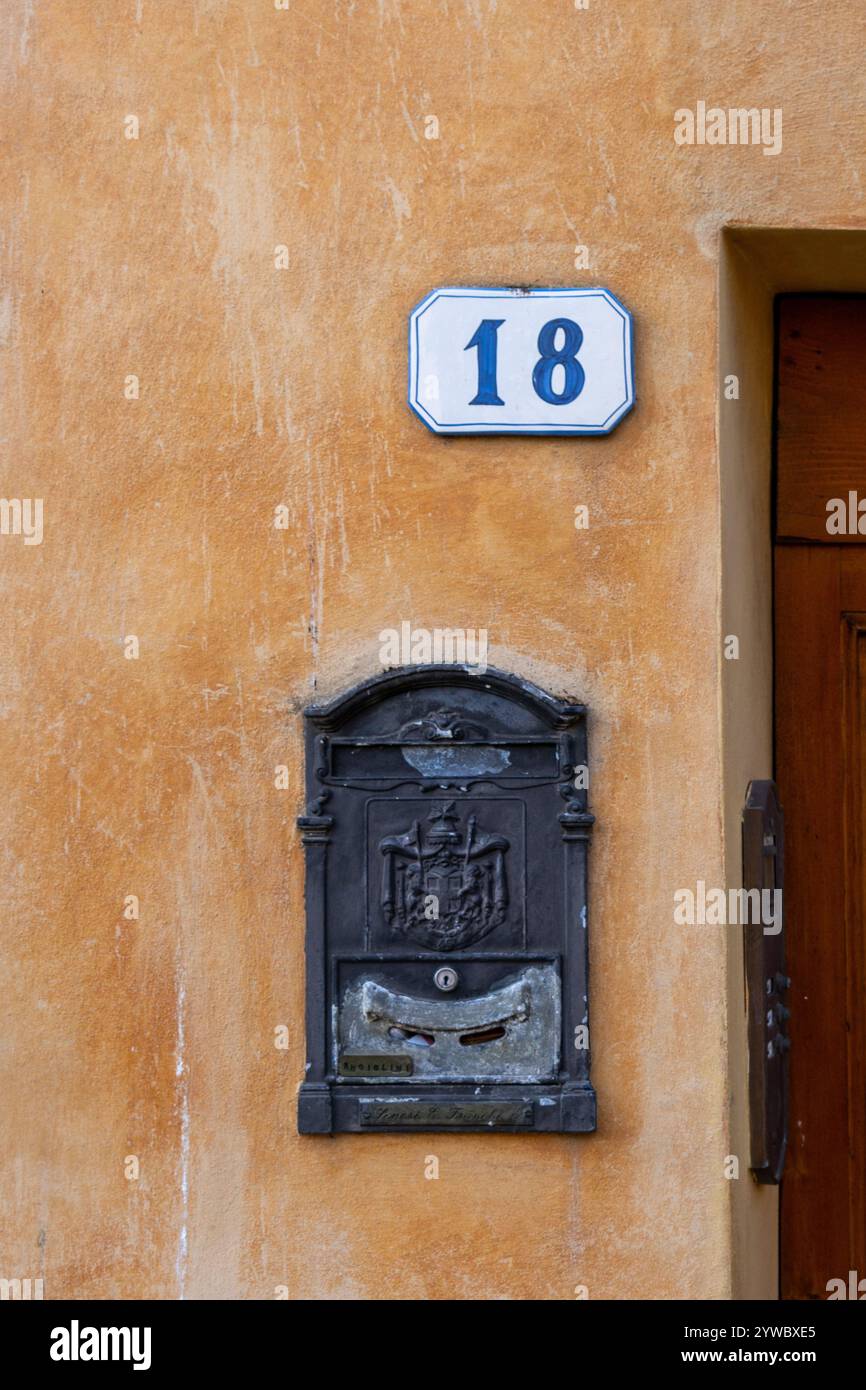 A post box on a stuccoed wall in the medieval walled town of ...