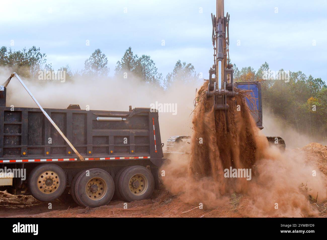 Process of moving earth into dump truck using an excavator on ...