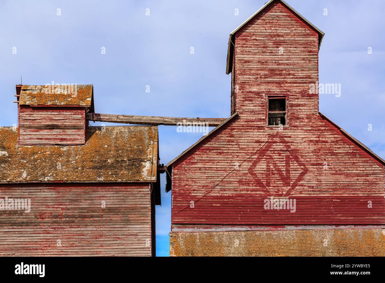 A red barn with a white cross on it. The barn is old and has a rustic ...