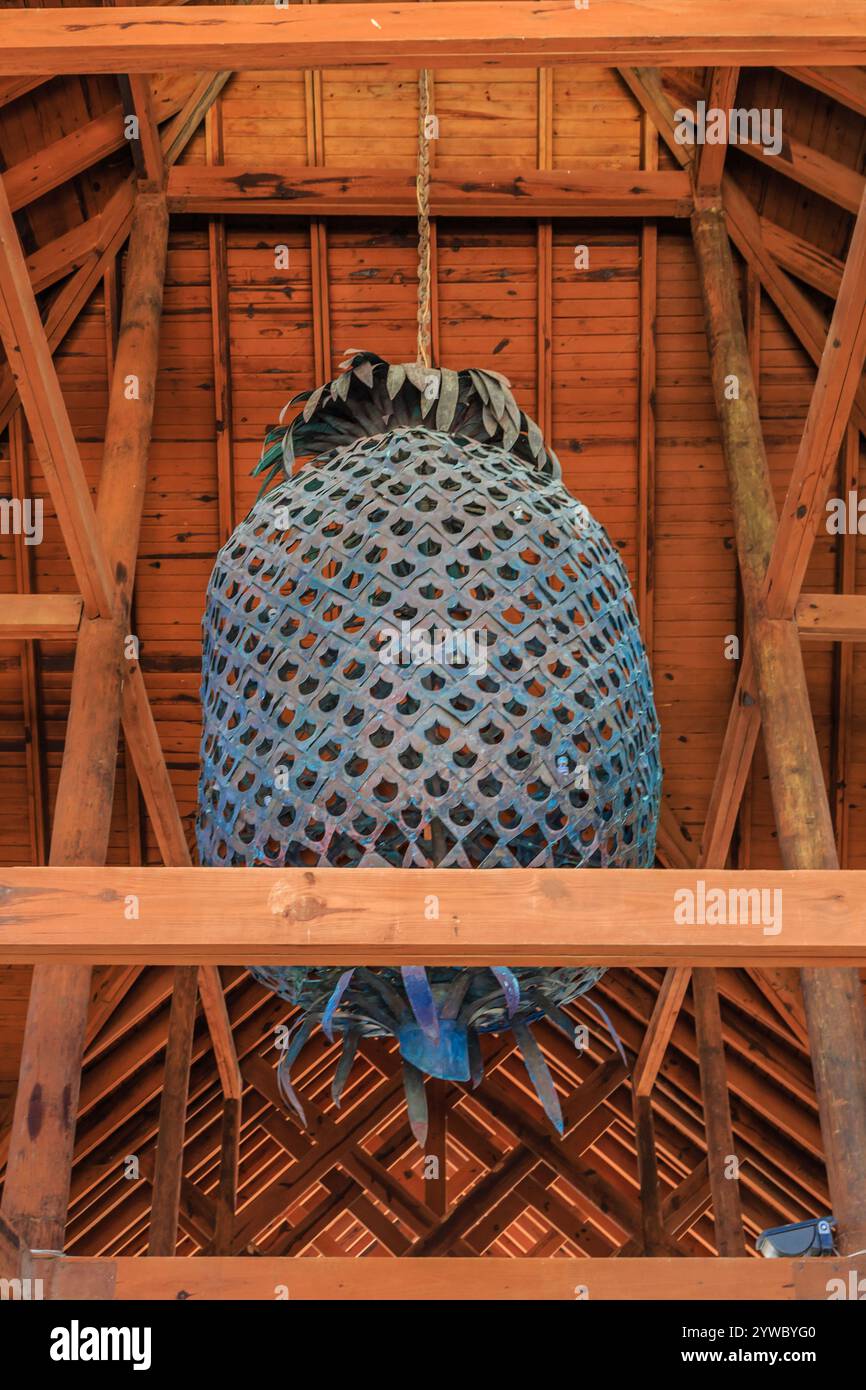 A blue object hanging from the ceiling with a wooden frame. The object ...