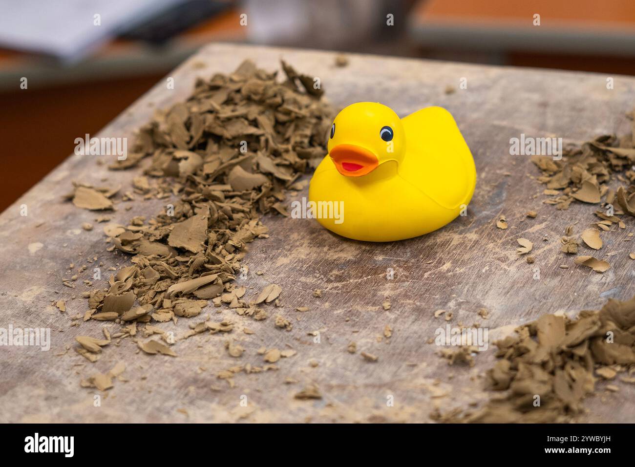 Yellow rubber duck with clay scraps on a ceramicist's table Stock Photo ...