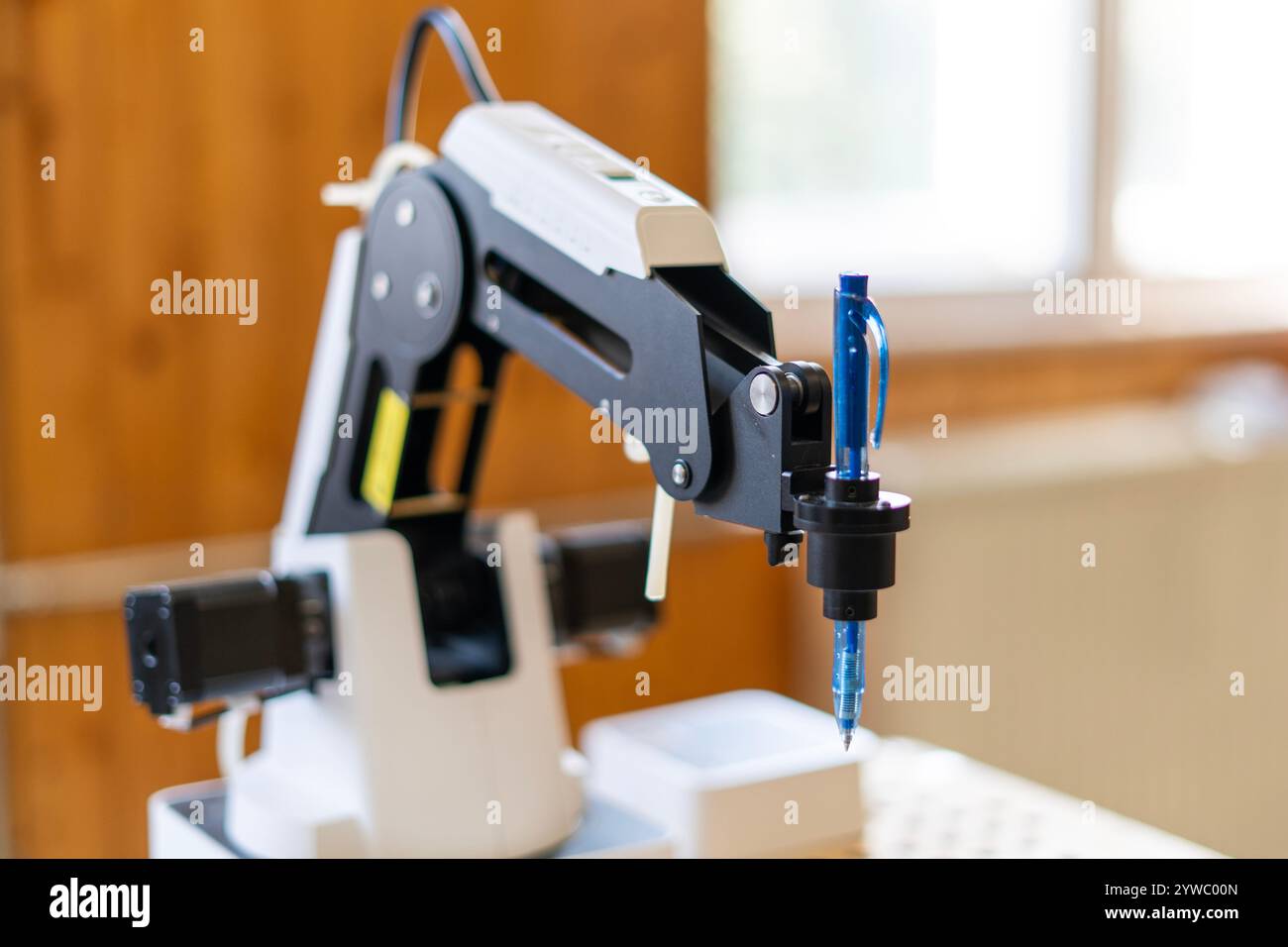 A robotic arm holding a pen Stock Photo - Alamy