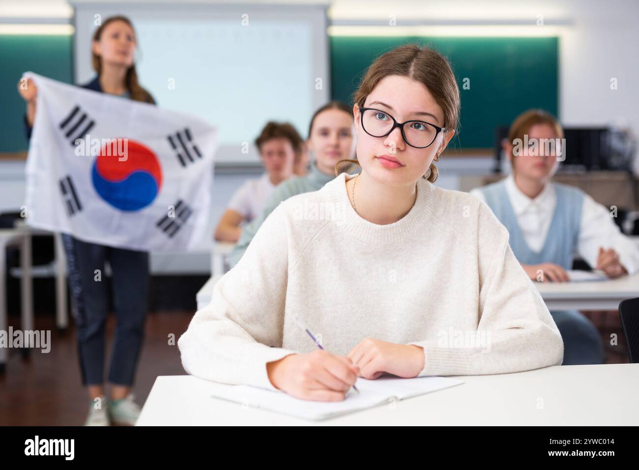 High school teacher holds the flag of South Korea in her hands and ...