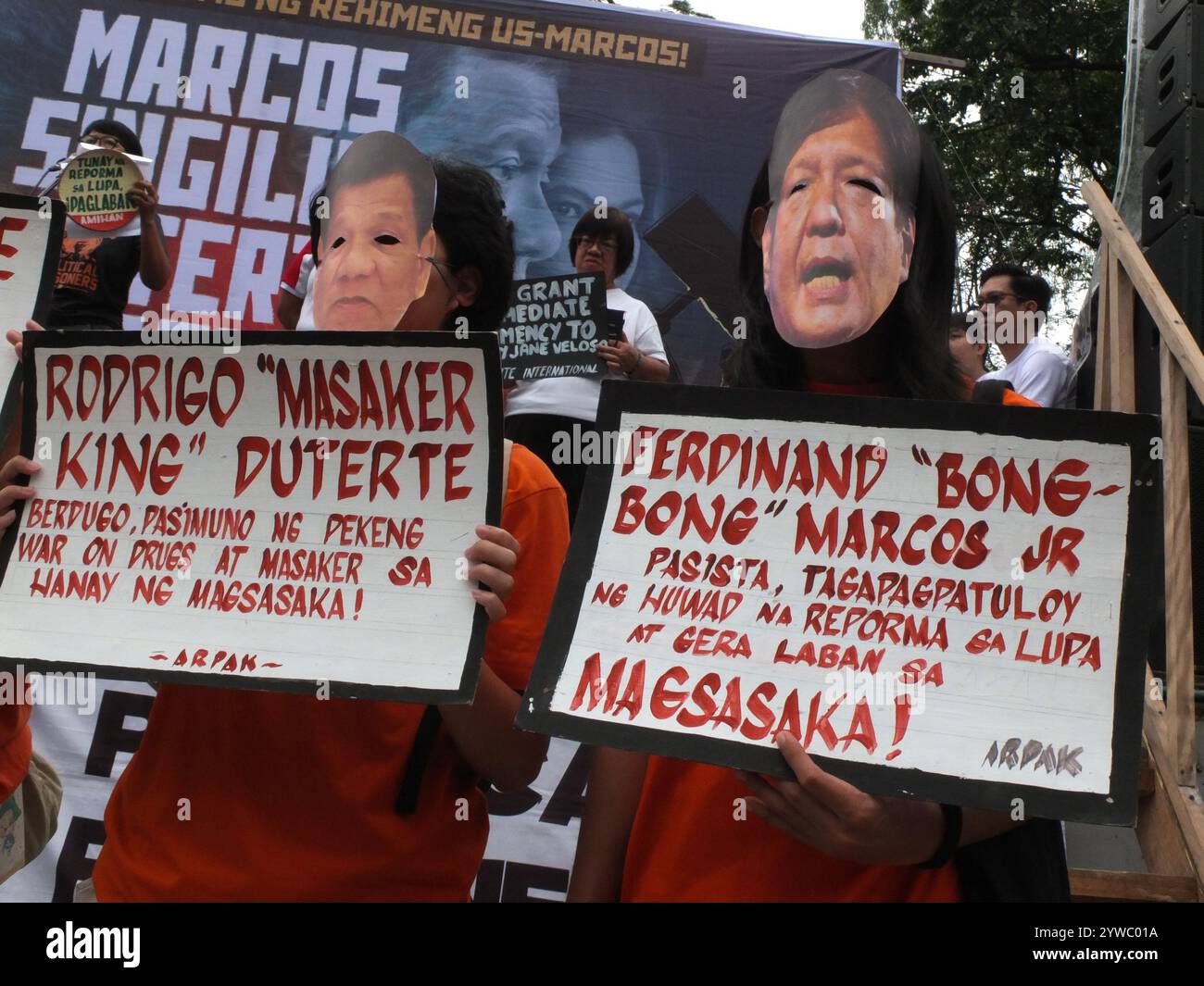 Protesters wearing a President Marcos Jr., former President Rodrigo ...