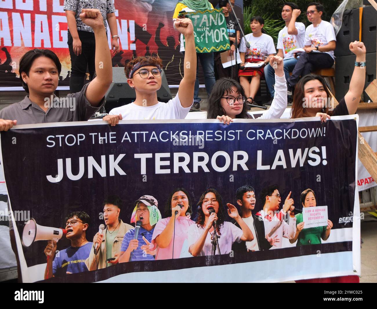 Protesters raised their fist while holding their streamer during the ...