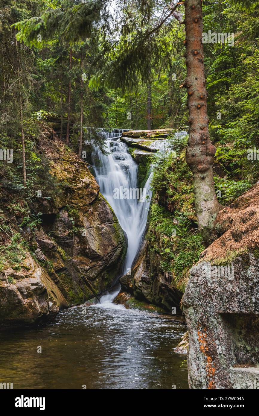 Beautiful giant Szklarka waterfall with giant rocks around and green ...