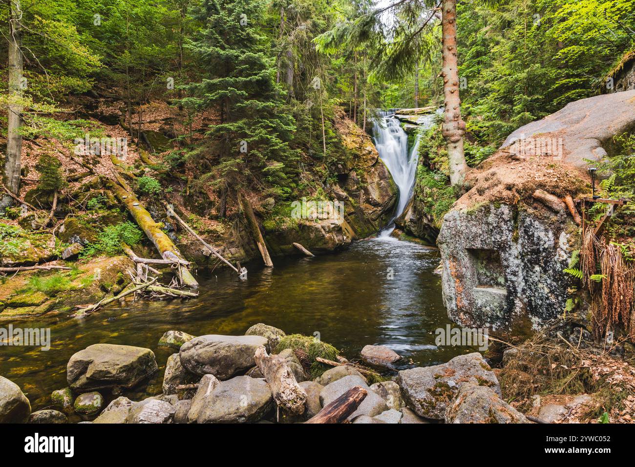 Beautiful giant Szklarka waterfall with giant rocks around and green ...