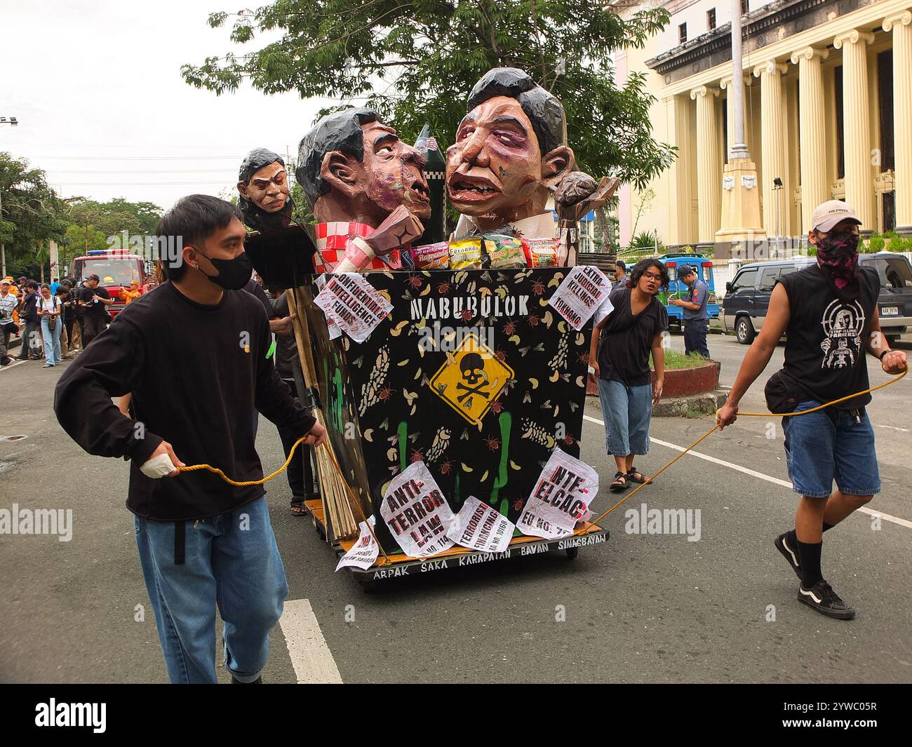 Protesters pulling the effigy of President Marcos Jr., and former ...