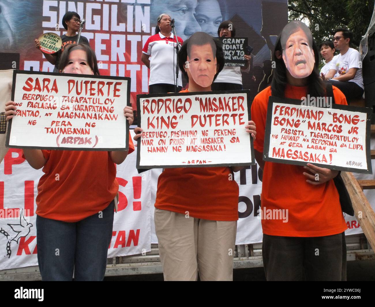 Protesters wearing a President Marcos Jr., former President Rodrigo ...