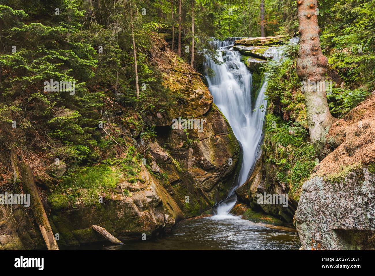 Beautiful giant Szklarka waterfall with giant rocks around and green ...