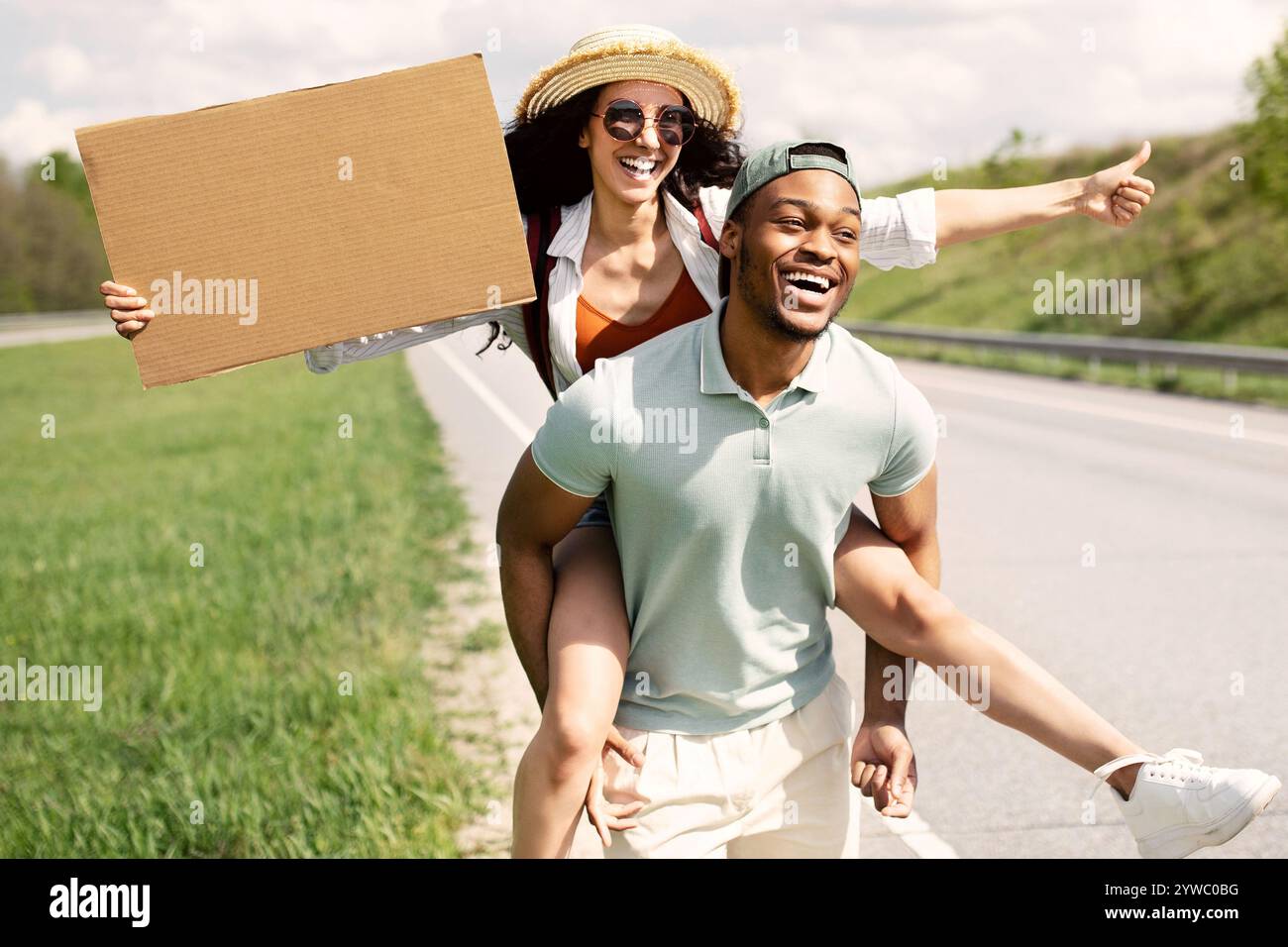 Cheerful black guy giving his girlfriend piggyback ride, young lady ...