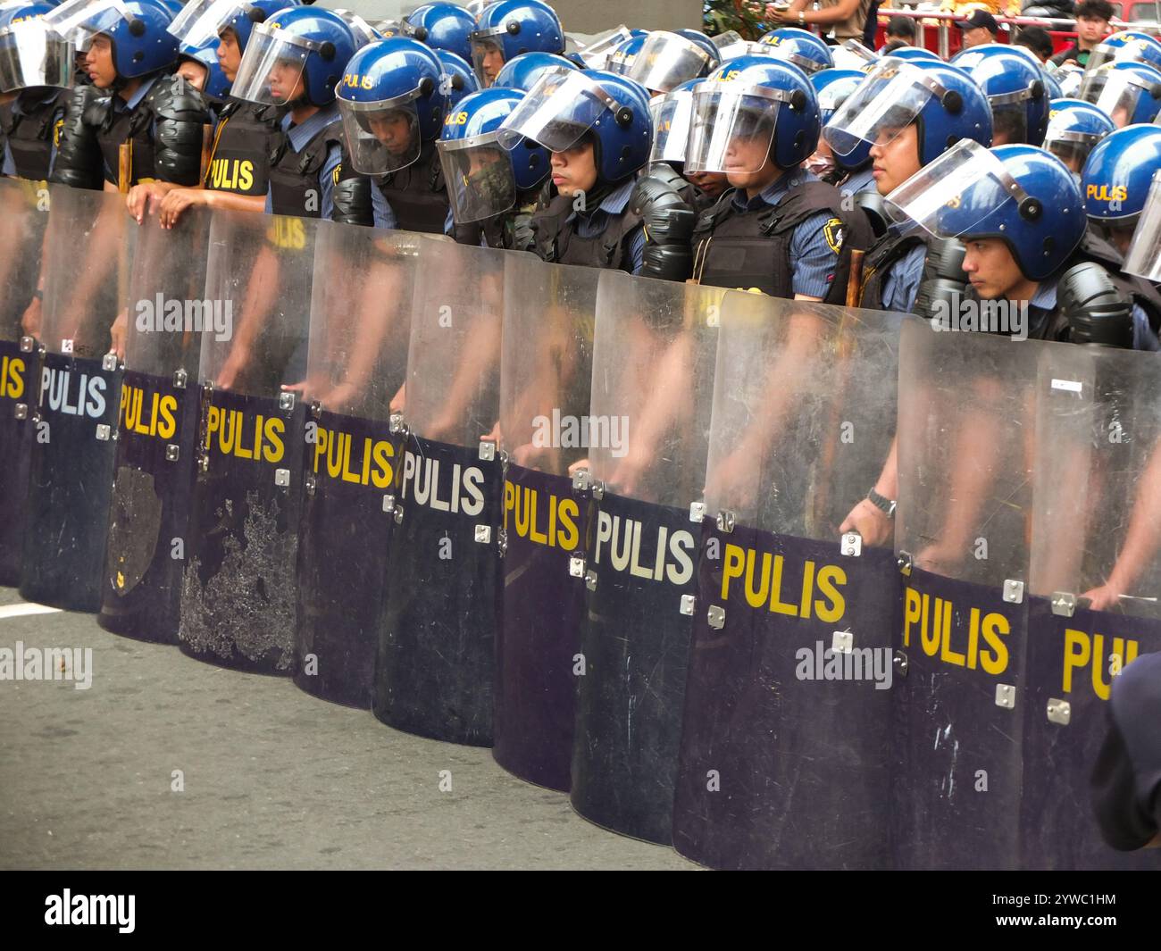 Civil police firmly hold their shields during the demonstration ...