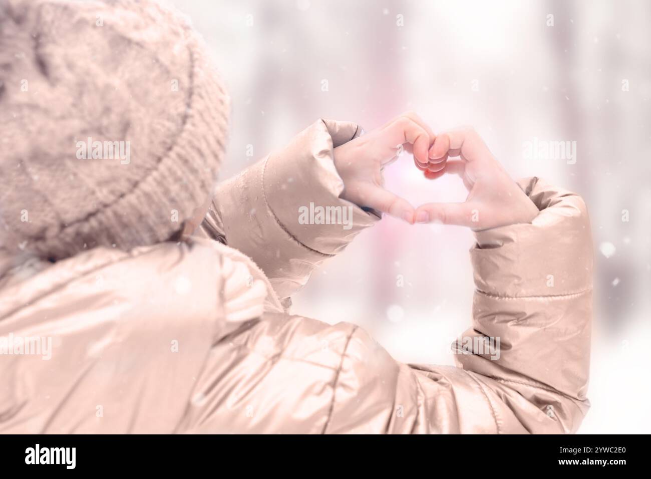 Winter heart gesture with sunshine and snow in a cozy atmosphere ...