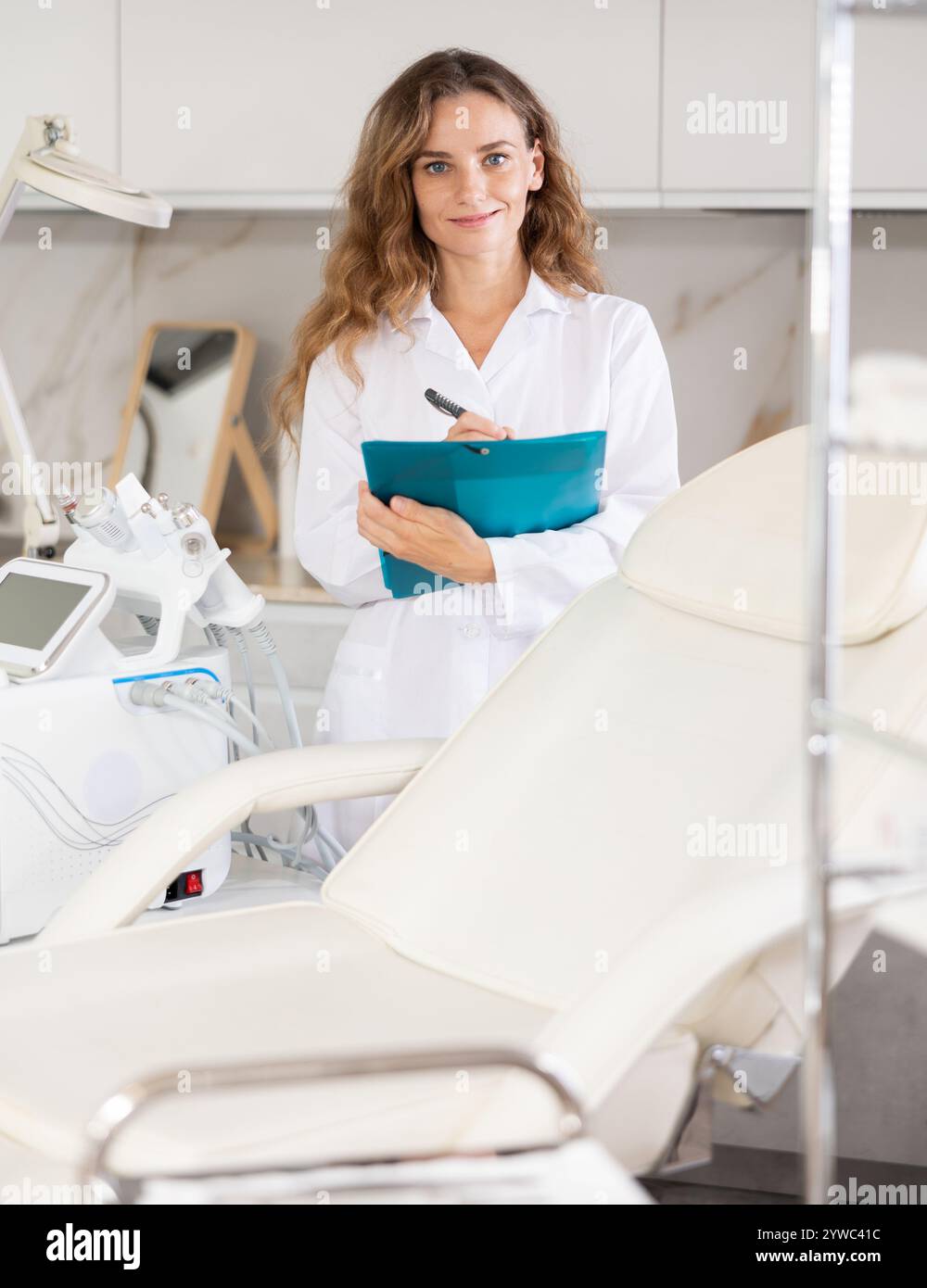 Young female doctor taking notes in medical room Stock Photo - Alamy