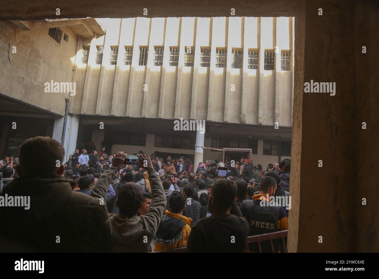 People gather at the Saydnaya prison in Damascus looking for loved ones ...