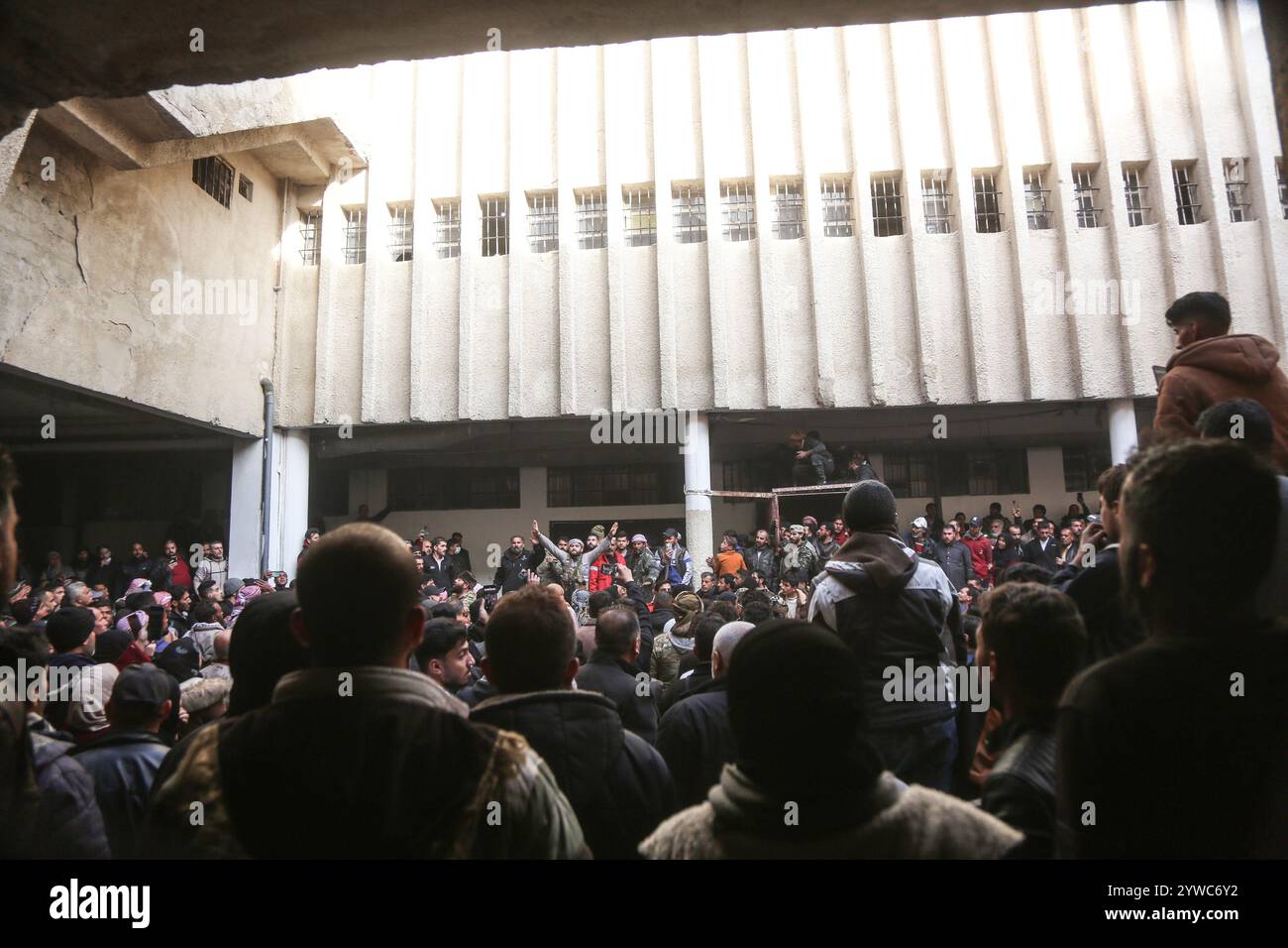 People gather at the Saydnaya prison in Damascus looking for loved ones ...