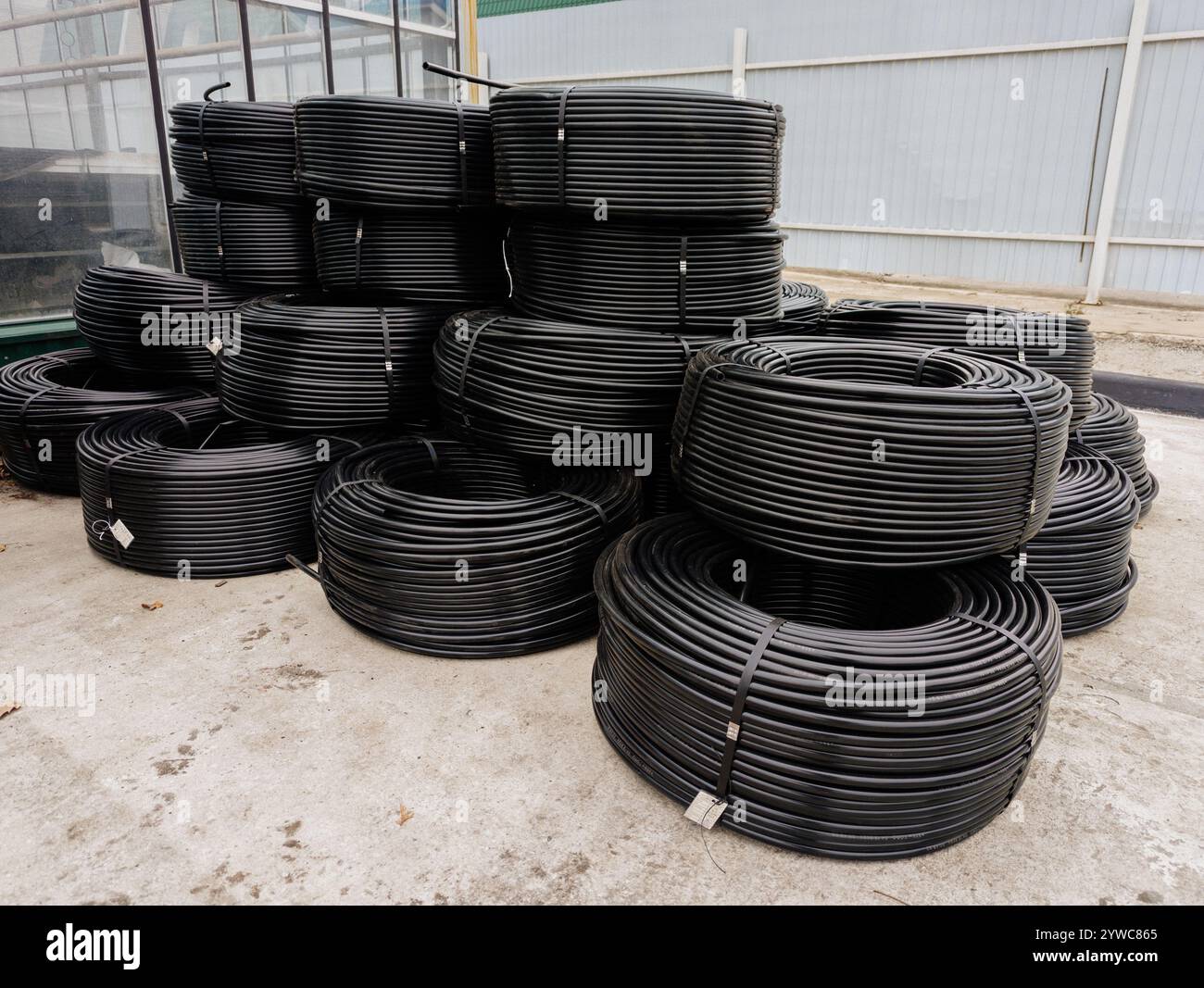 Rolled up black construction wire Stock Photo - Alamy