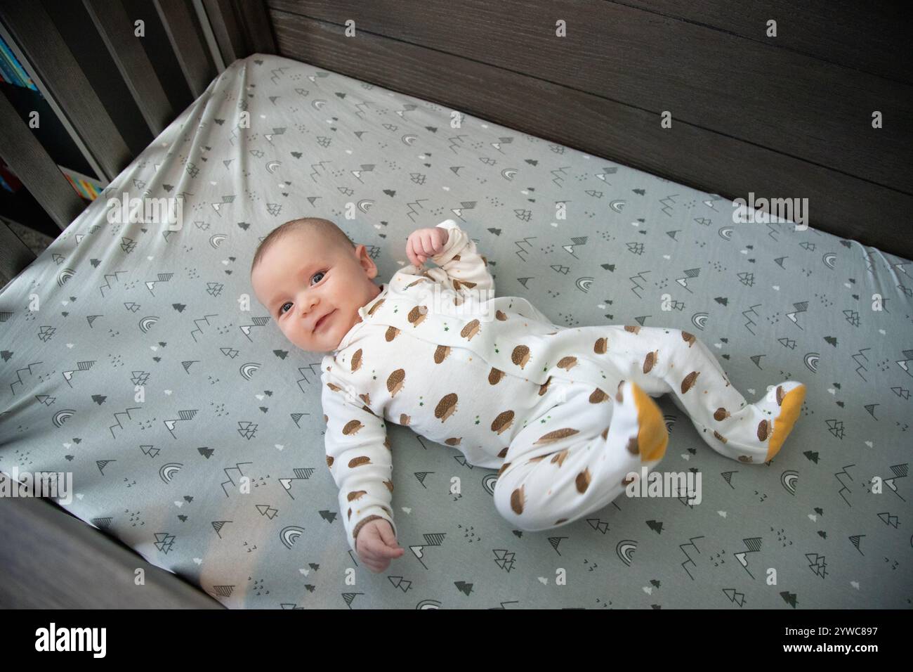 Baby boy lying in cot hi-res stock photography and images - Alamy