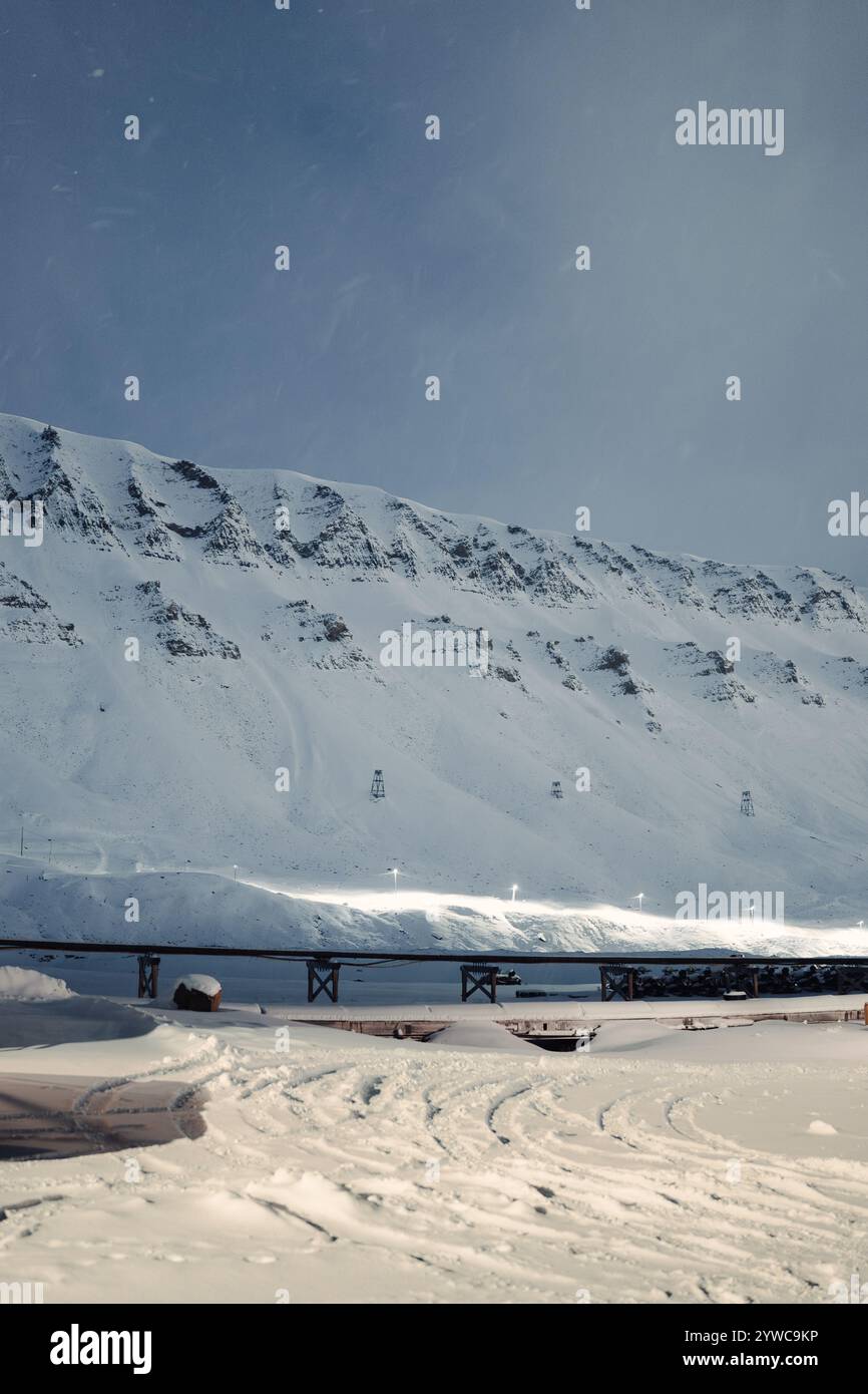 Pipes under snowy mountains in Longyearbyen, Svalbard due to permafrost ...