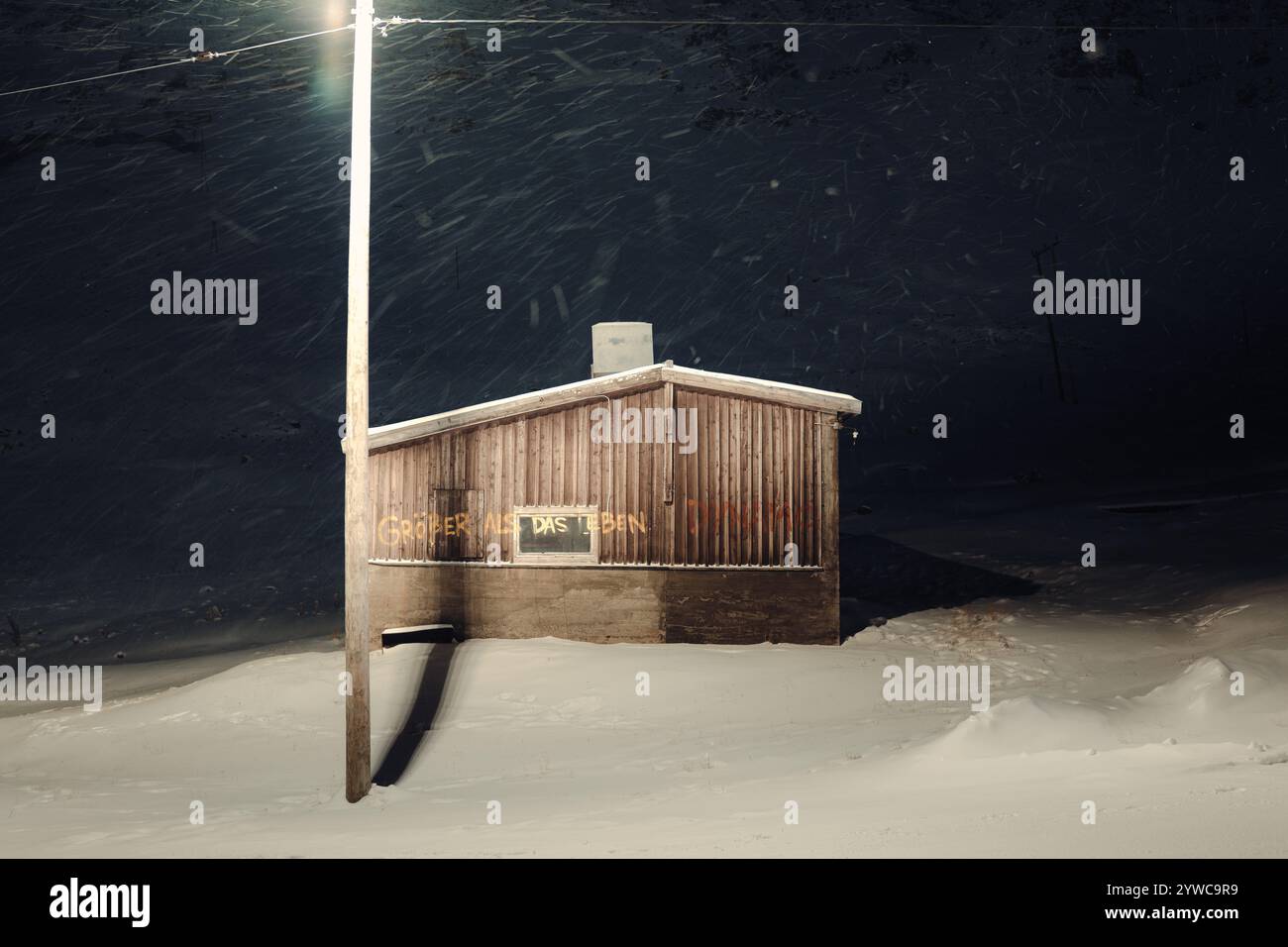 Wooden cabin in the snow in the polar night in Longyearbyen, Svalbard ...