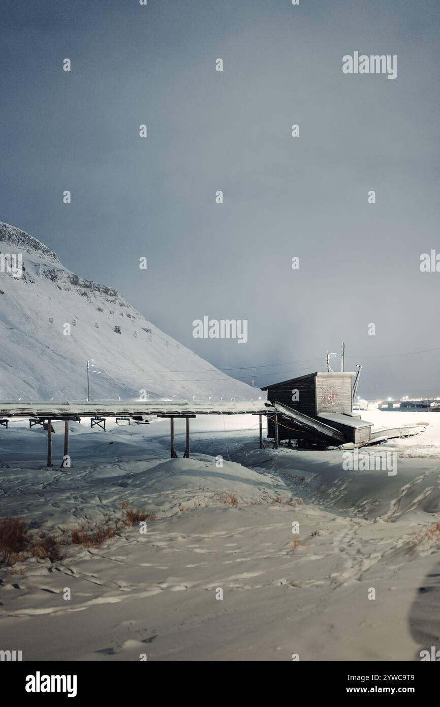 Permafrost pipes above ground into shed in the snow in Longyearbyen ...