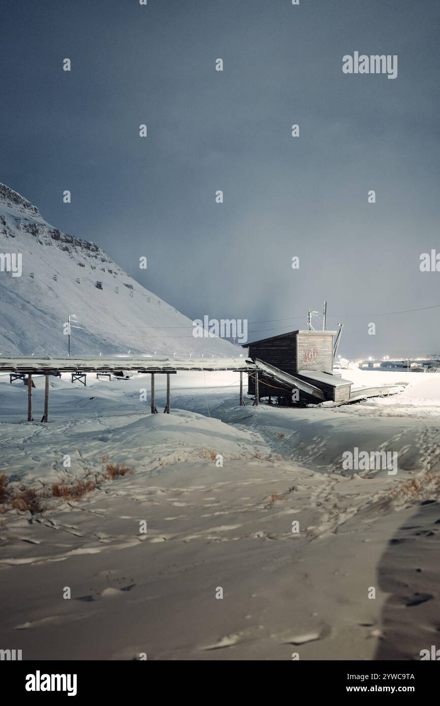 Shed with permafrost pipes over snowy ground in Longyearbyen, Svalbard ...