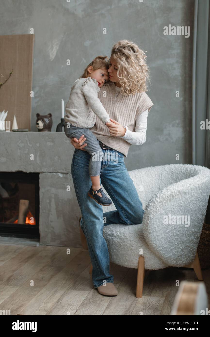 Young woman standing in a living room cuddling and consoling her ...