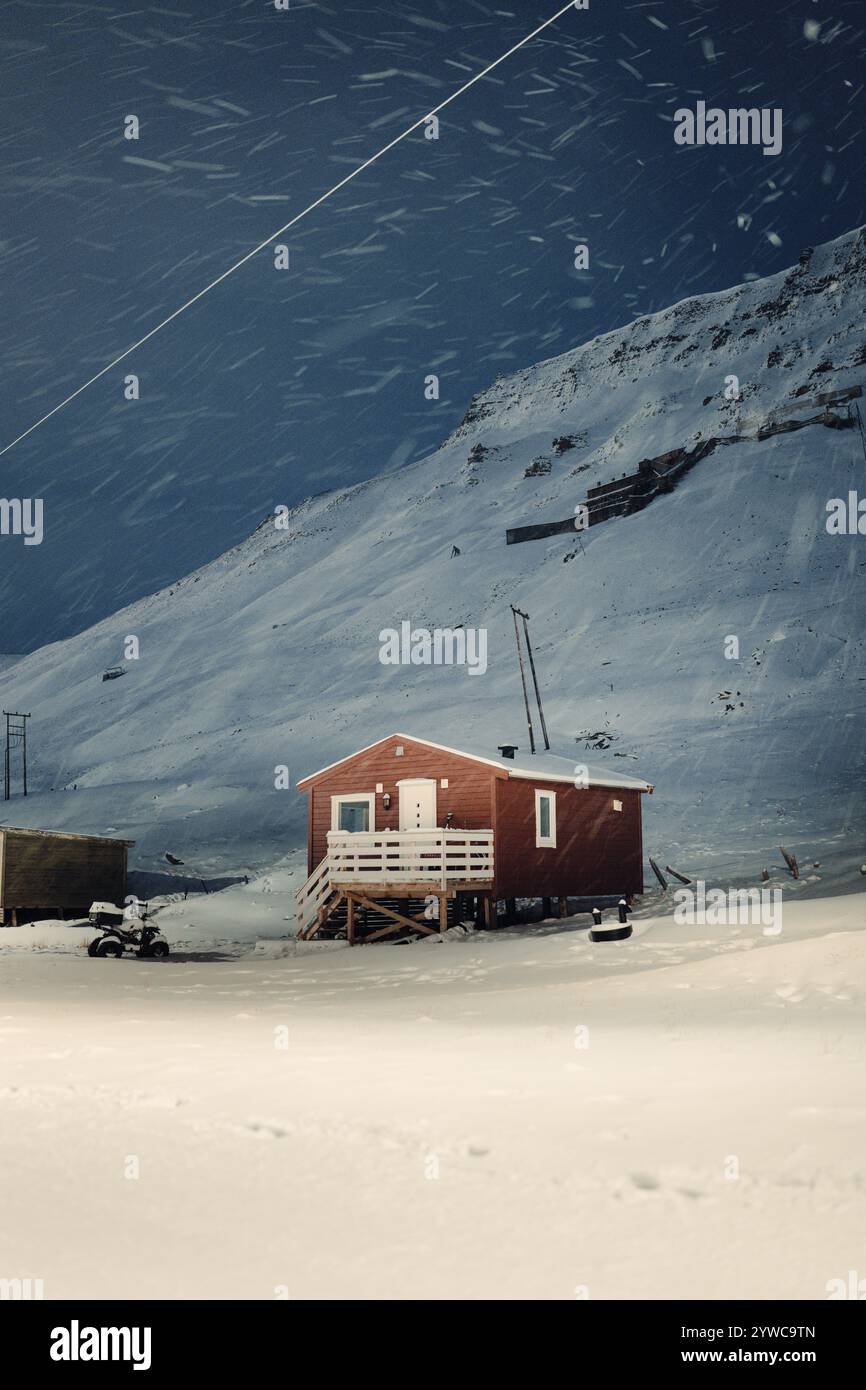 Snowing on wooden cabin under mountain in Longyearbyen, Svalbard Stock ...
